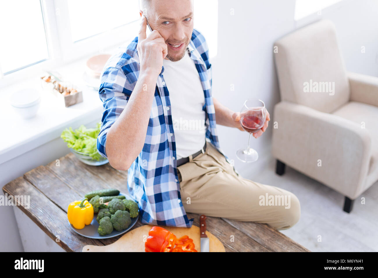 Attractive handsome man answering phone call Stock Photo - Alamy