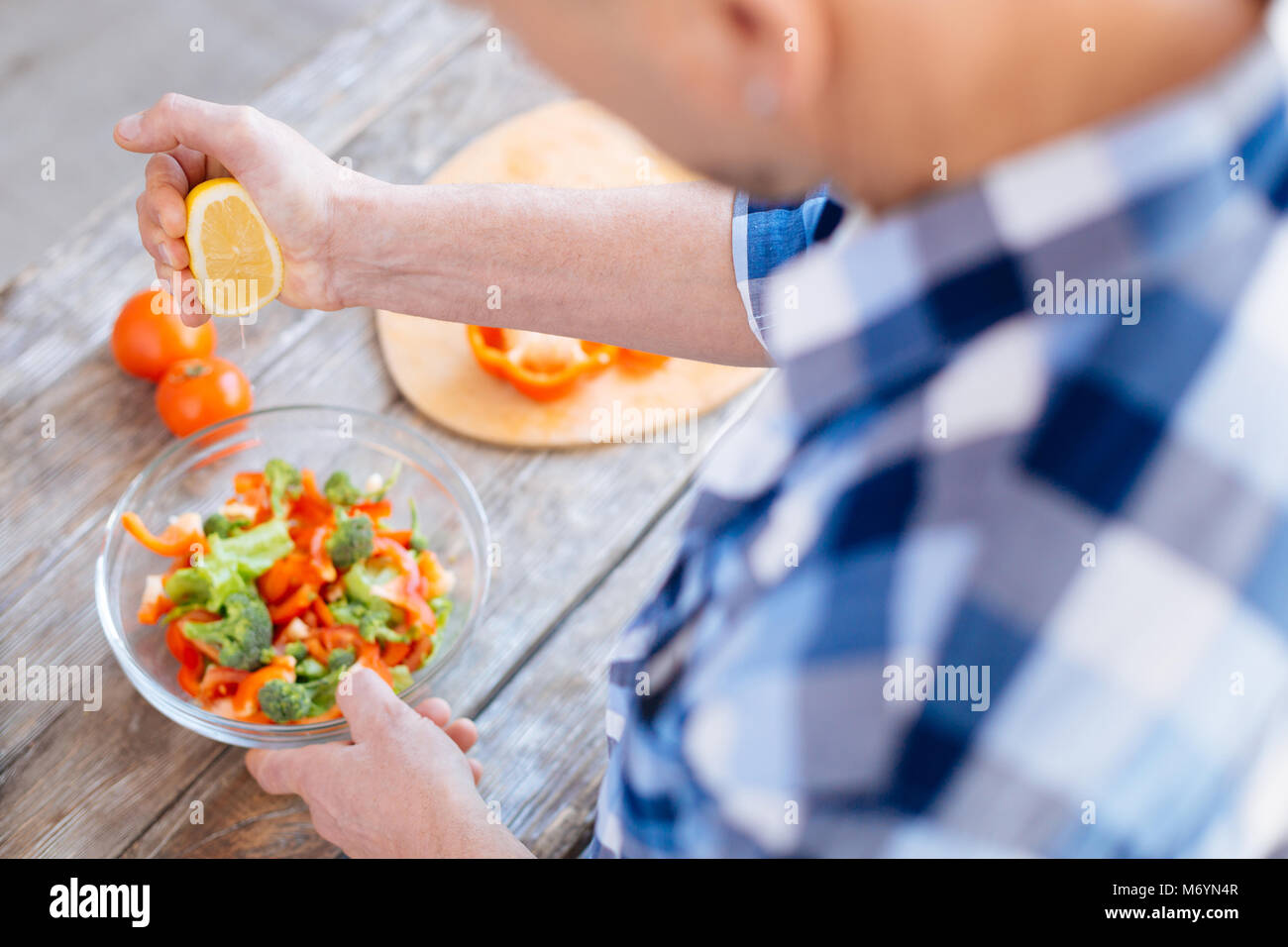 Young man adding bitter lemon juice Stock Photo - Alamy