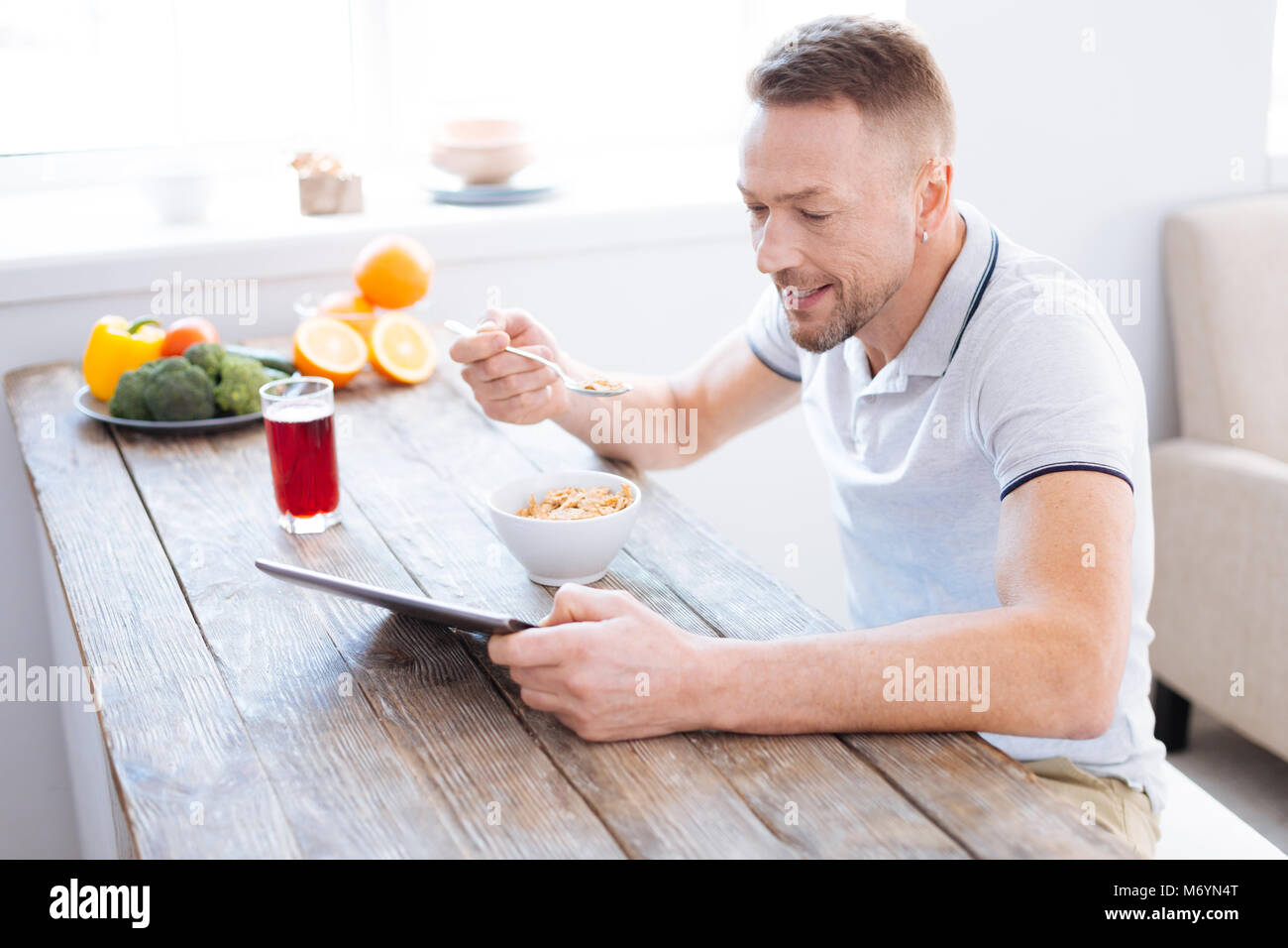 Happy satisfied man eating granola Stock Photo - Alamy