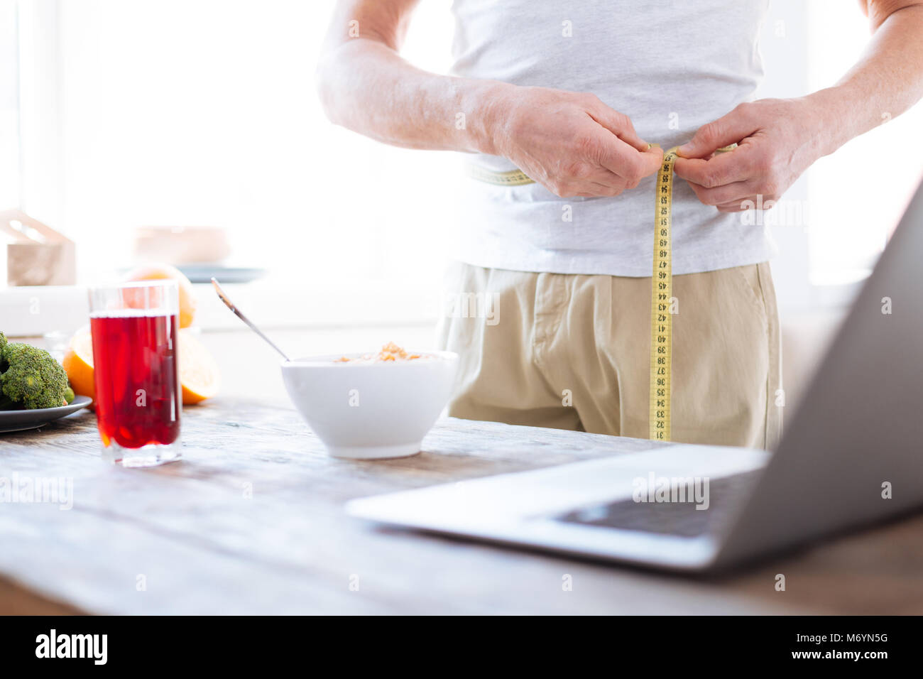 Young male hands holding metre ruler Stock Photo - Alamy