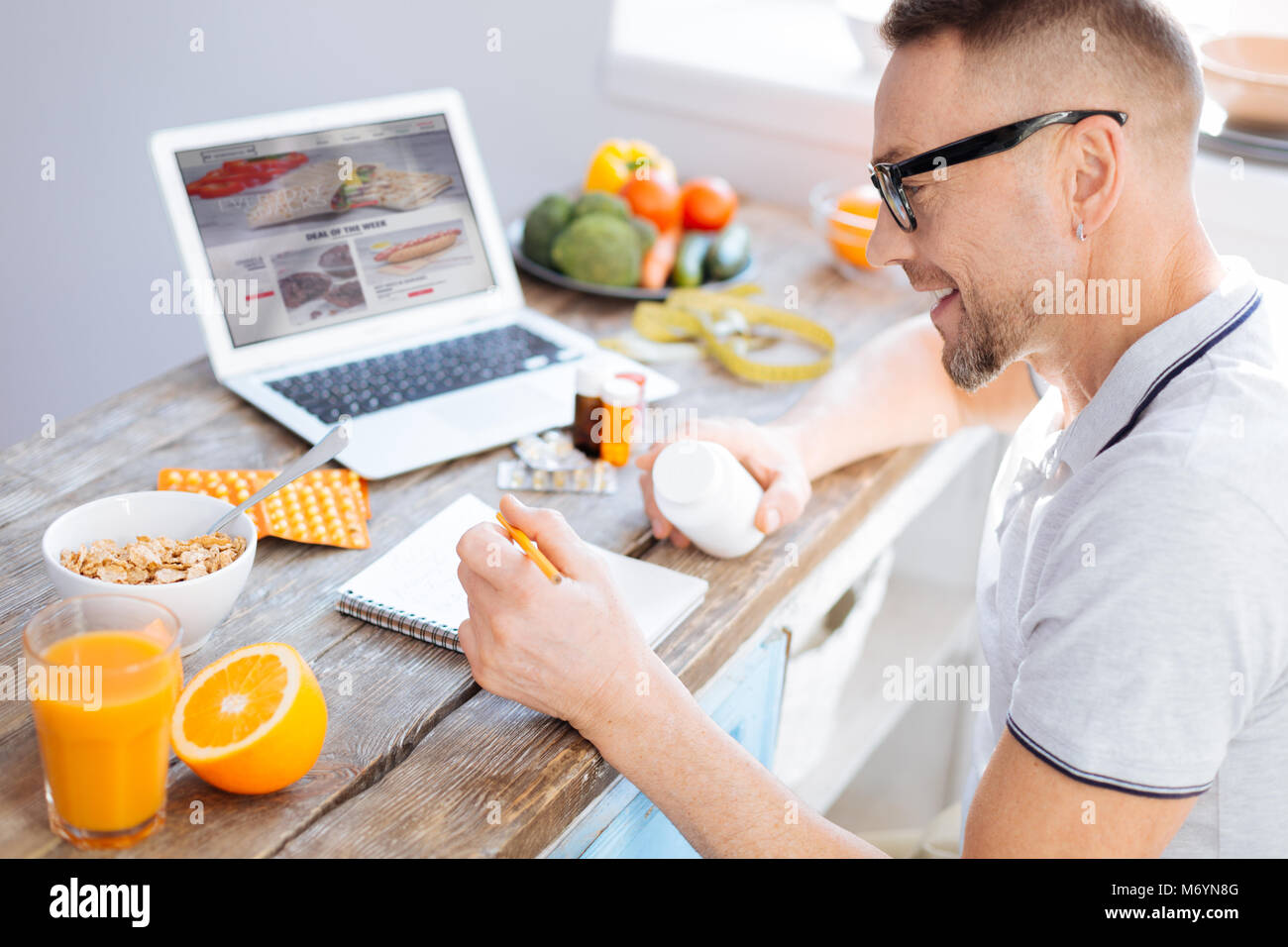 Happy merry man compiling graphic Stock Photo - Alamy