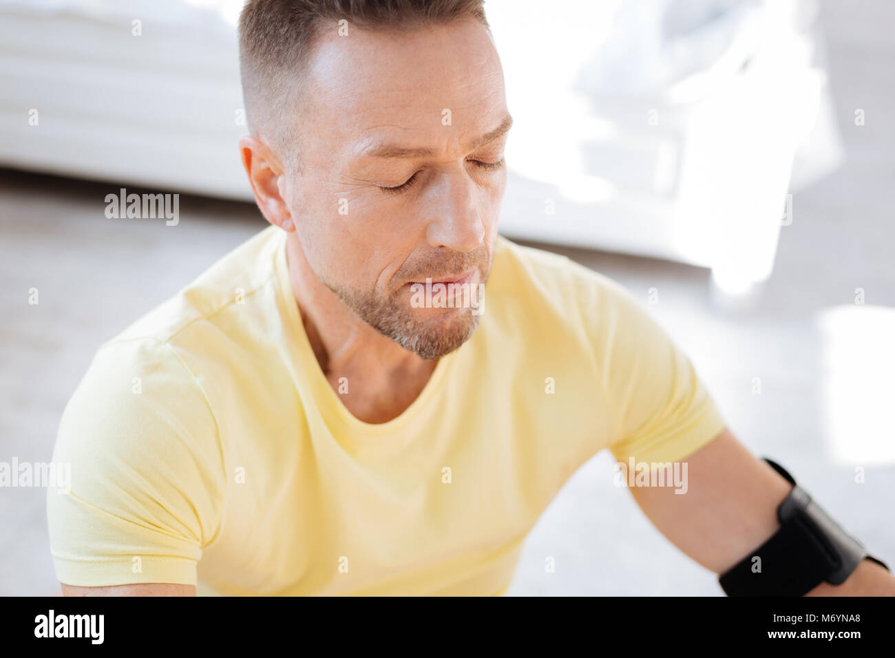 Focused calm man meditating alone Stock Photo - Alamy