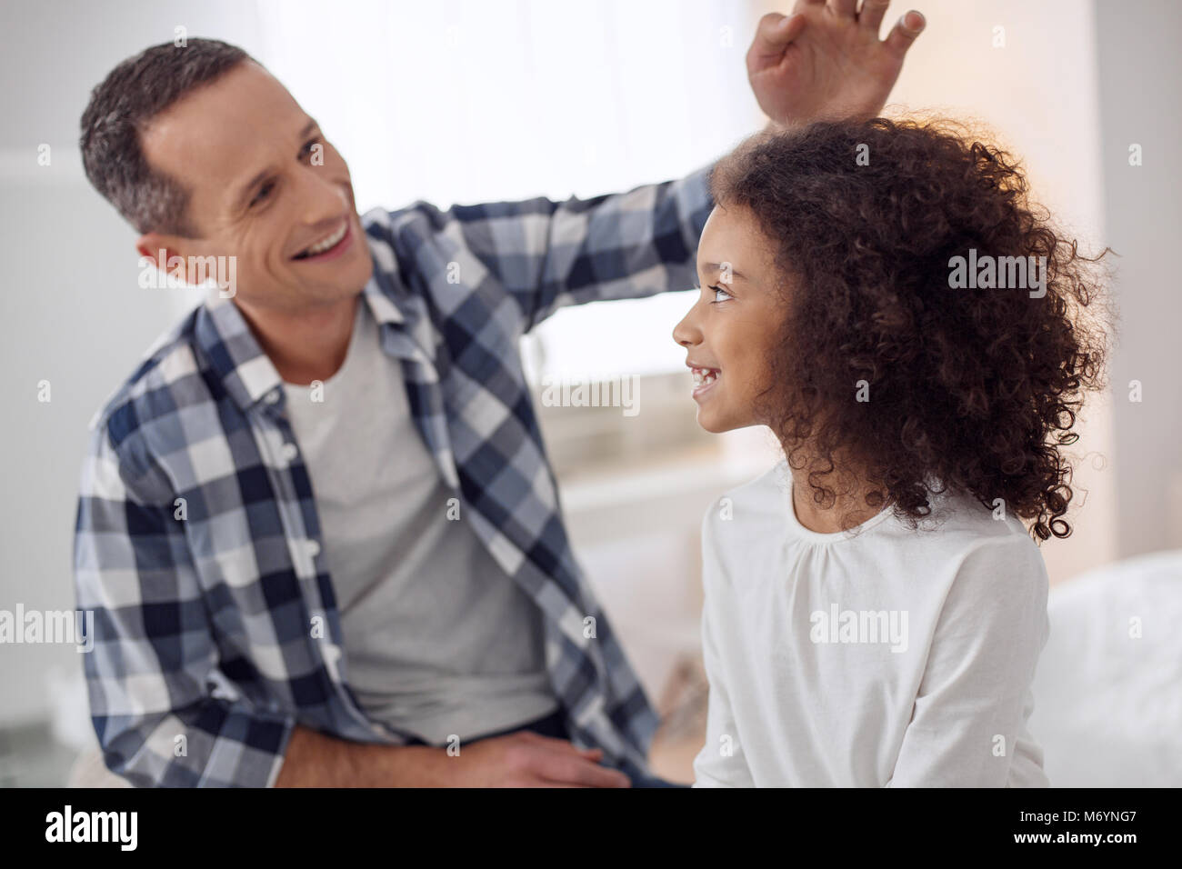 Smiling father talking with his daughter Stock Photo - Alamy