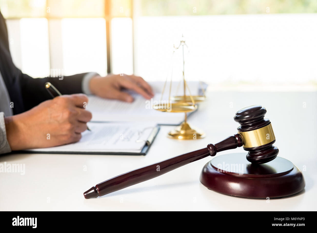 lawyer judge reading and writes the document in court at his desk Stock ...