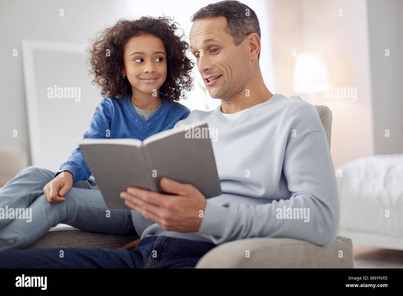 Happy father reading a book for his daughter Stock Photo - Alamy