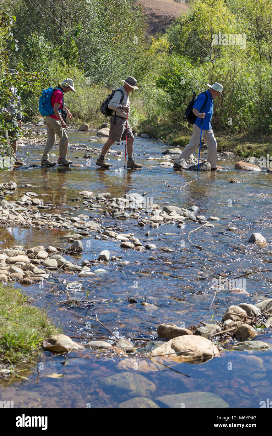 Oaxaca, Mexico - People cross a stream while hiking in the West Etla ...