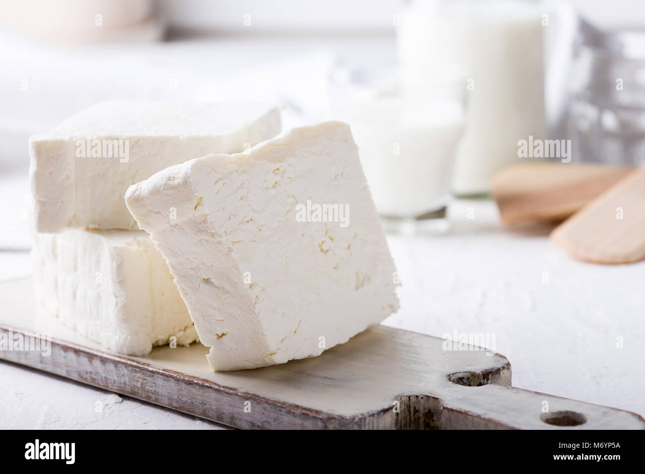 Fresh cottage cheese on rustic white wooden board, homemade organic ...