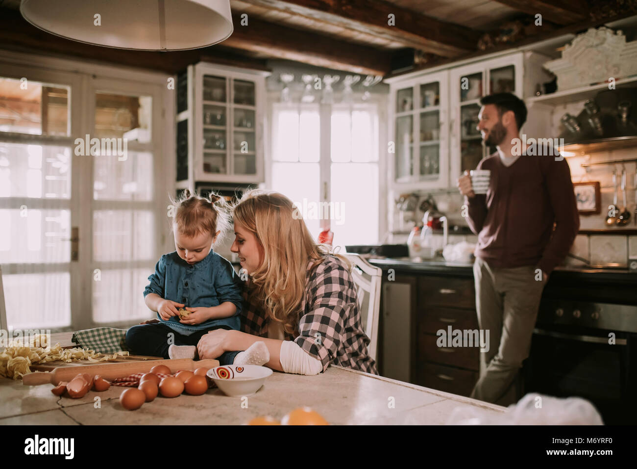 Happy family making pasta in the kitchen at home Stock Photo - Alamy