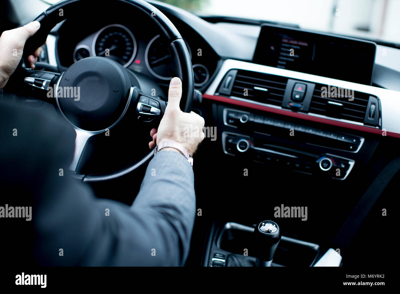 Back view of an handsome smiling business man driving his car Stock ...