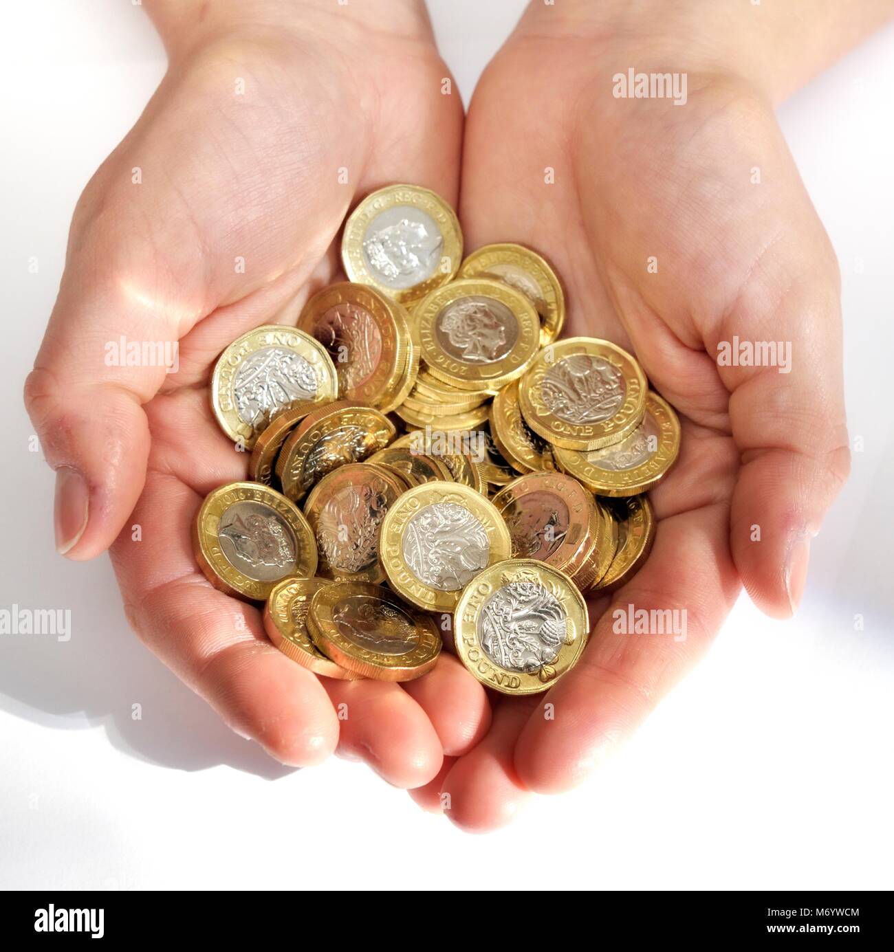 Handful of pound coins hi-res stock photography and images - Alamy