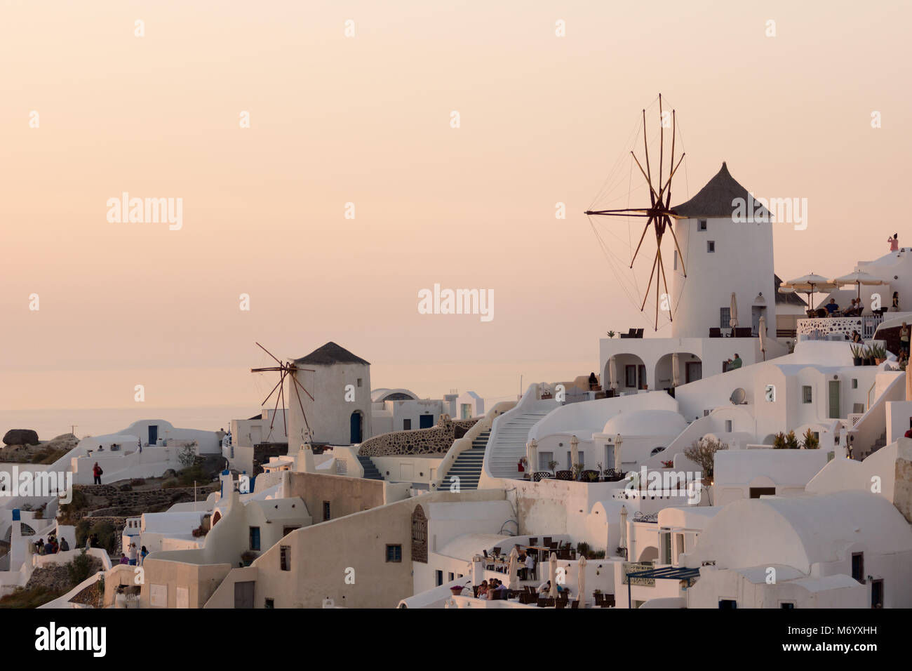 Amazing Sunset over white windmills in town of Oia and panorama to ...