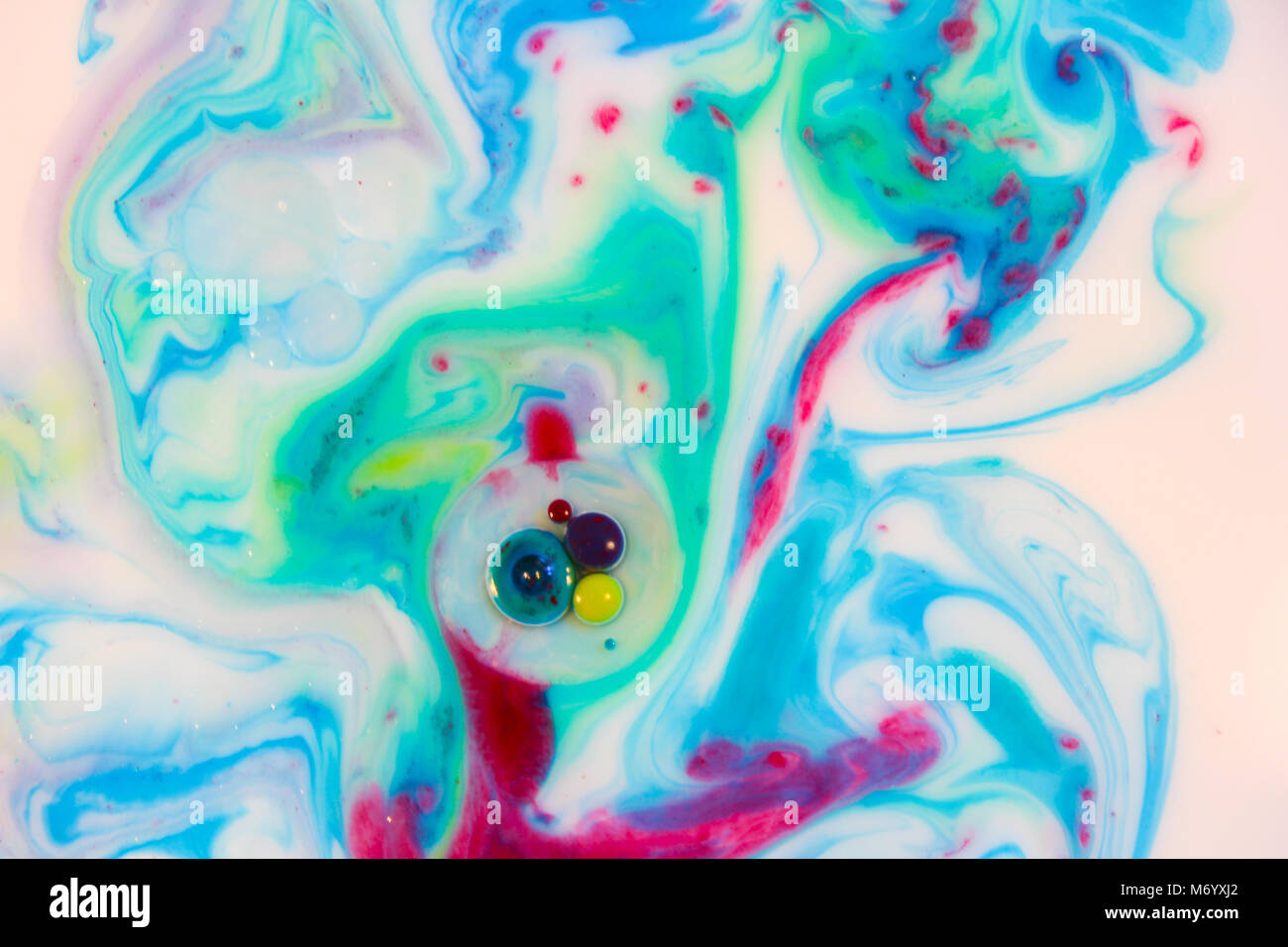 Abstract background, blue, green and red color mix together in milk ...