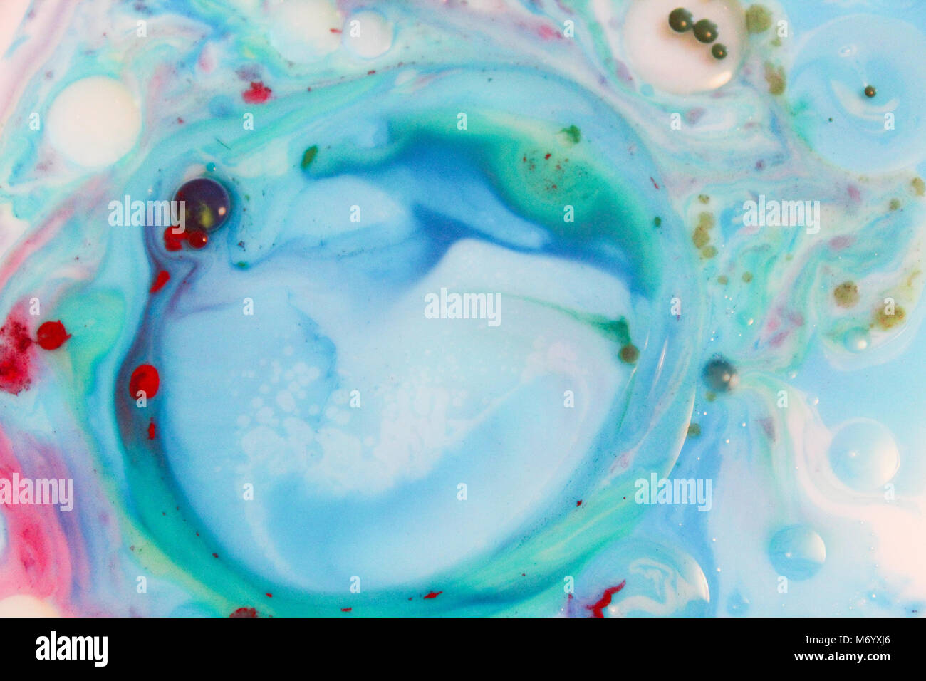 Abstract background, green and red color mix together in milk with ...