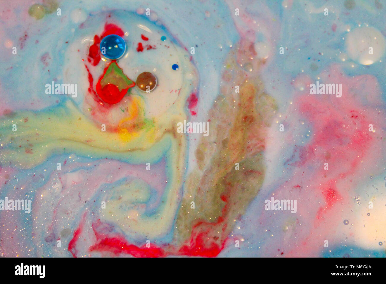 Abstract background, blue and yellow color mix together in milk with ...