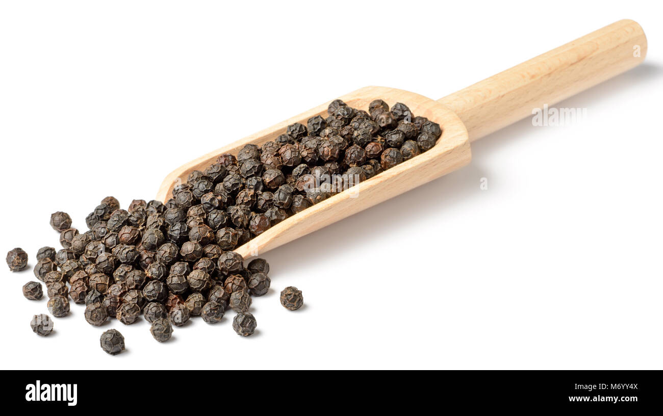whole black peppercorns in the wooden scoop, isolated on white ...