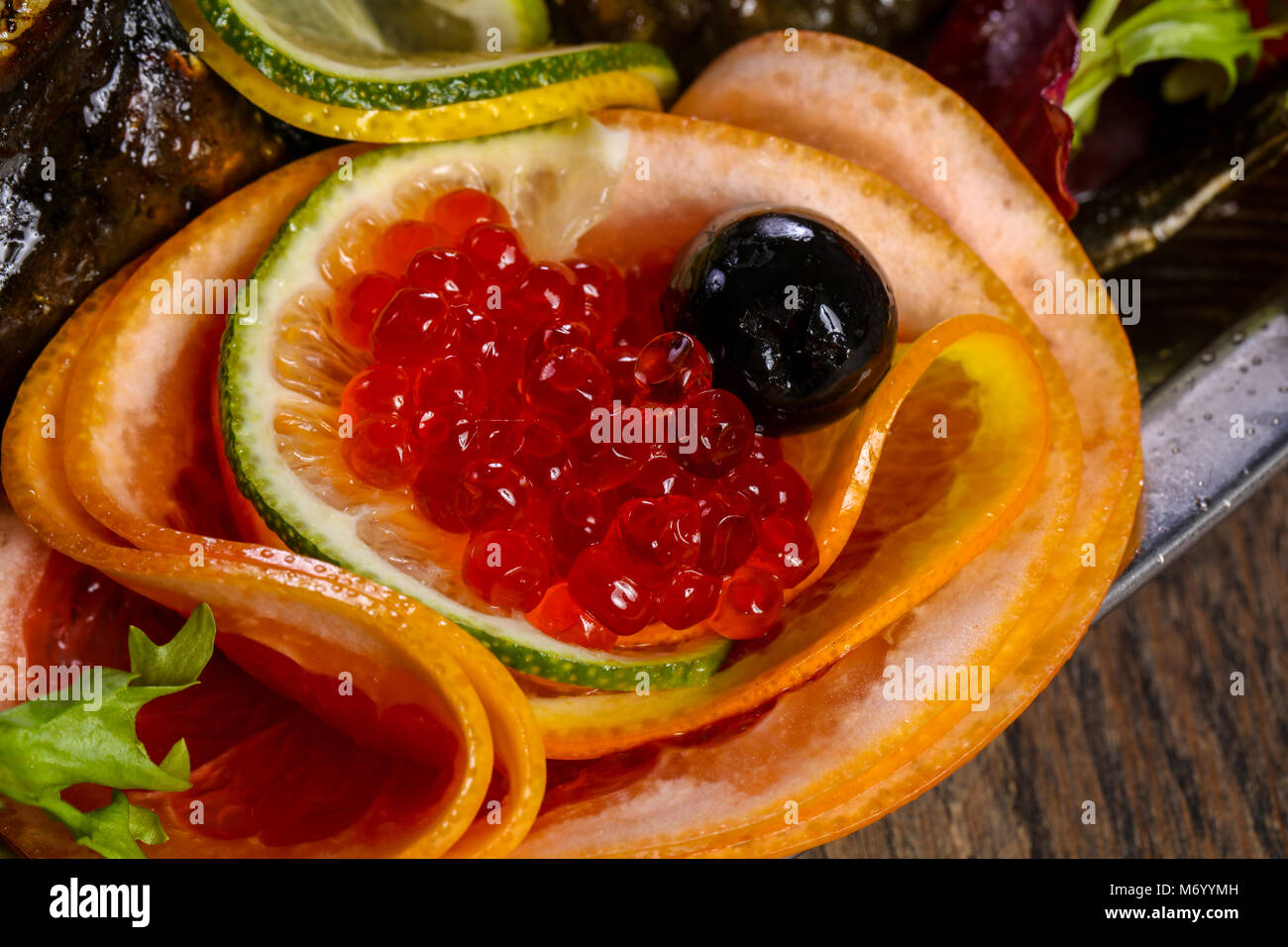 Red caviar with orange and lime Stock Photo - Alamy
