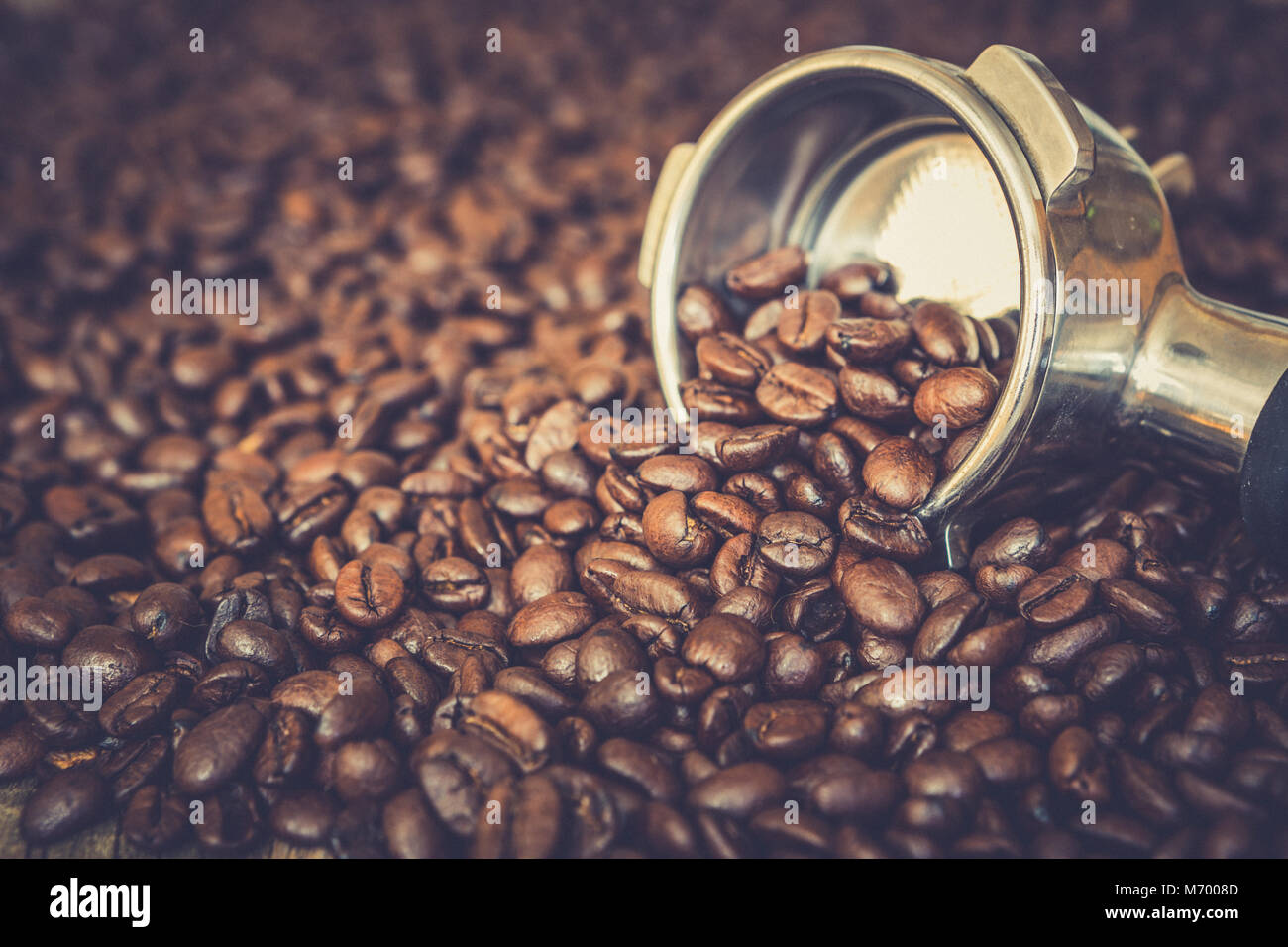 Metal espresso machine scoop on roasted coffee beans background Stock ...