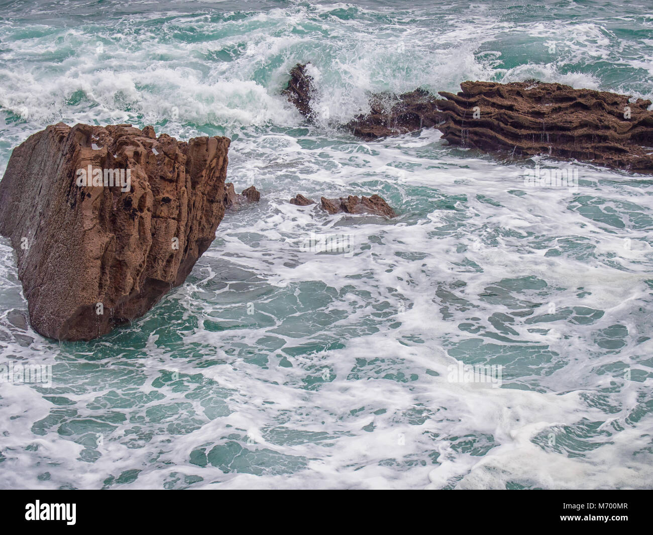 Stormy ocean between rocks Stock Photo - Alamy