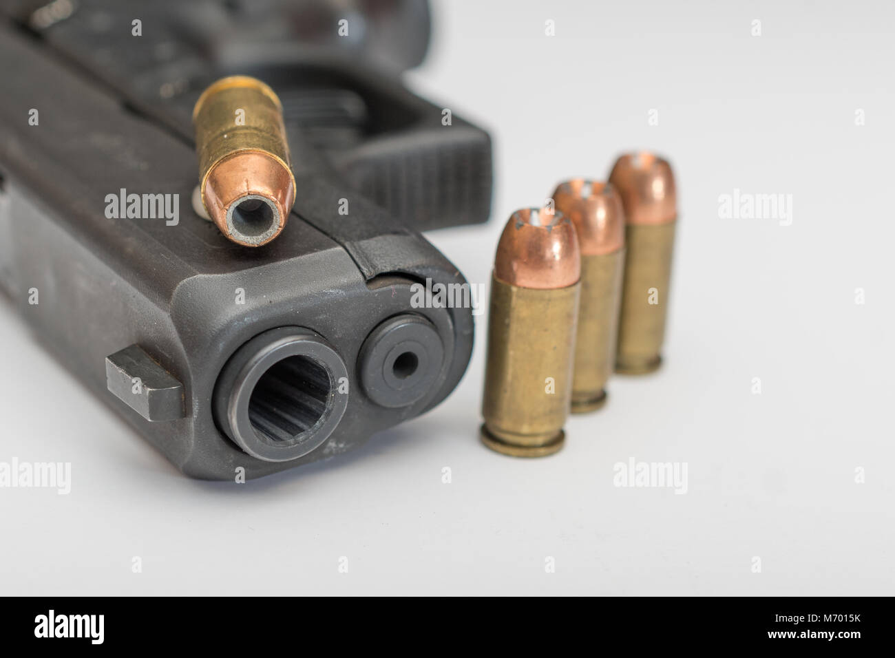 Hand gun up close with ammunition laying around it Stock Photo - Alamy