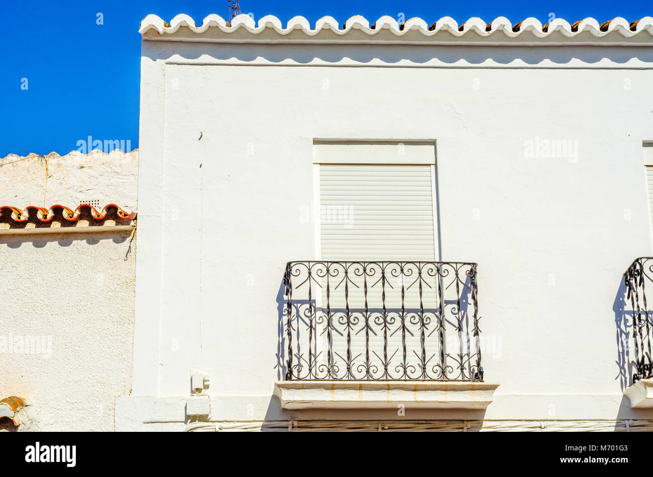 Stylish balcony with a metal railing, solid architectural element, a ...