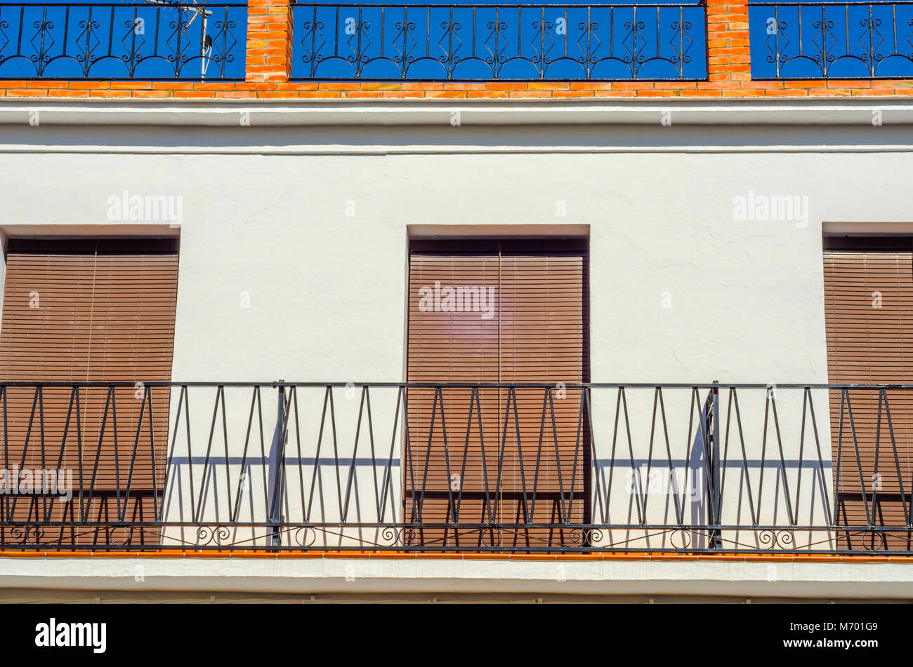 Stylish balcony with a metal railing, solid architectural element, a ...