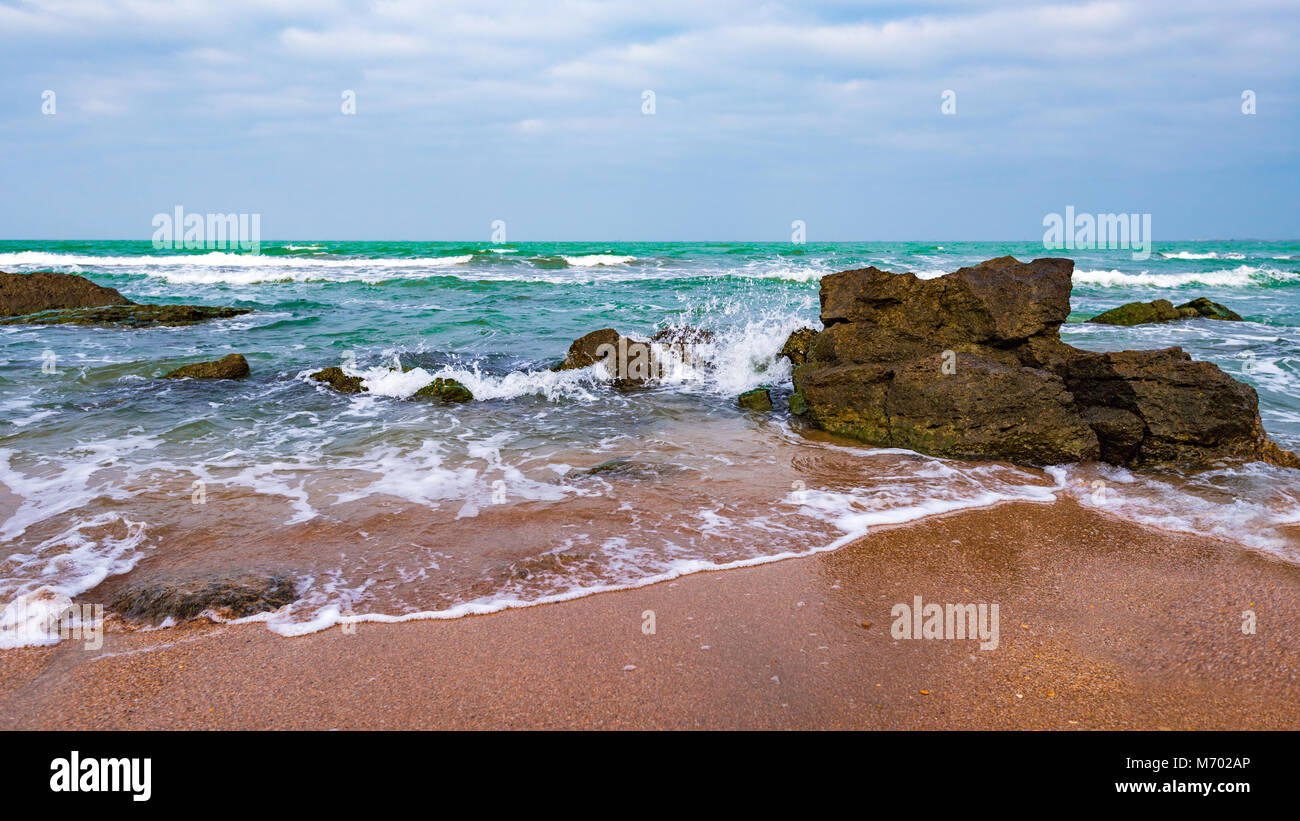 Seashore with rocks and clear turquoise water Stock Photo - Alamy