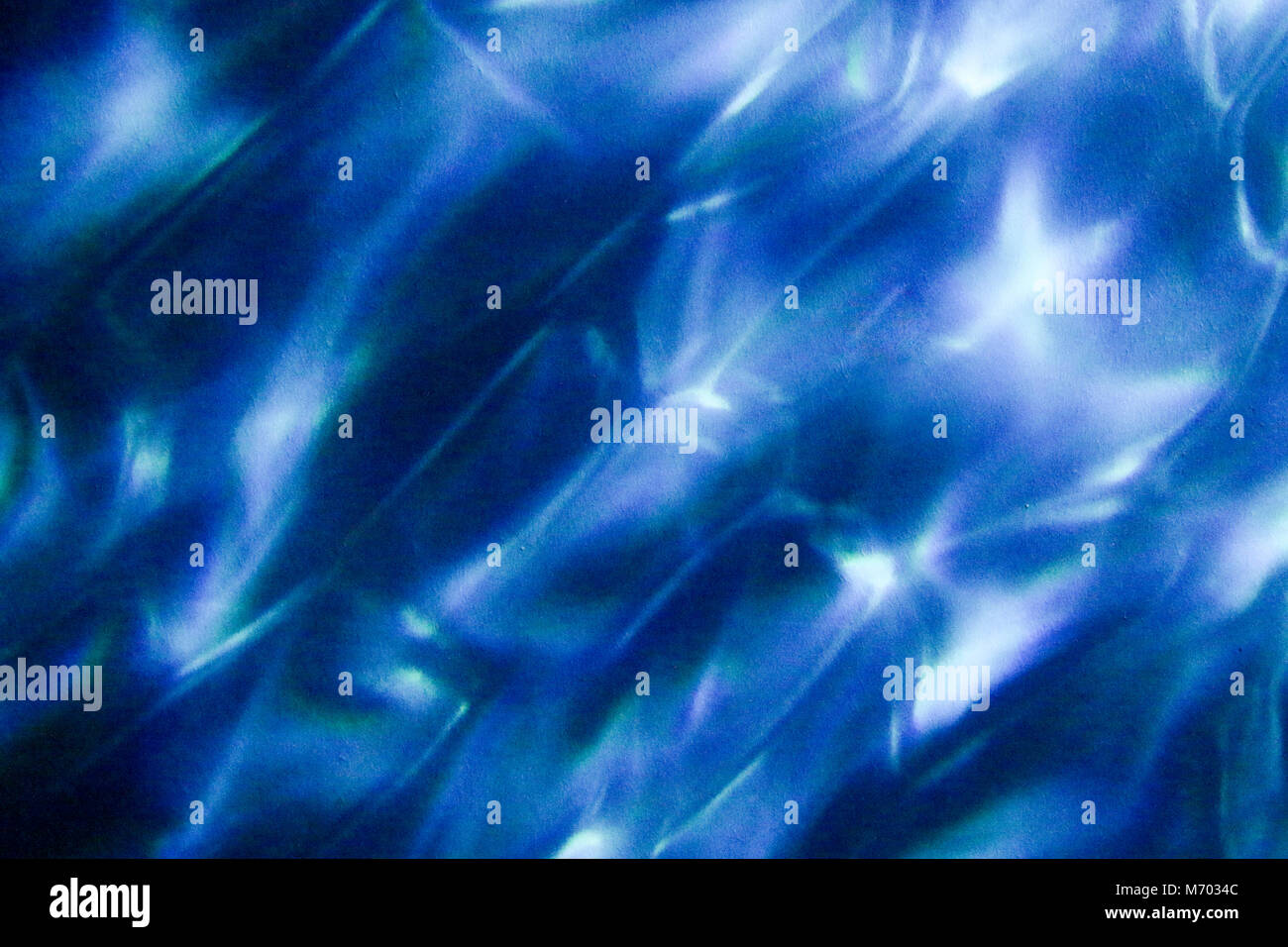 Water flows along the wall of an aquarium, abstract texture, shiny ...