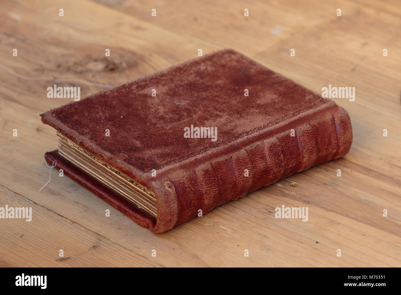 Antique Wrinkled Leather Book on Wooden Plank Stock Photo - Alamy