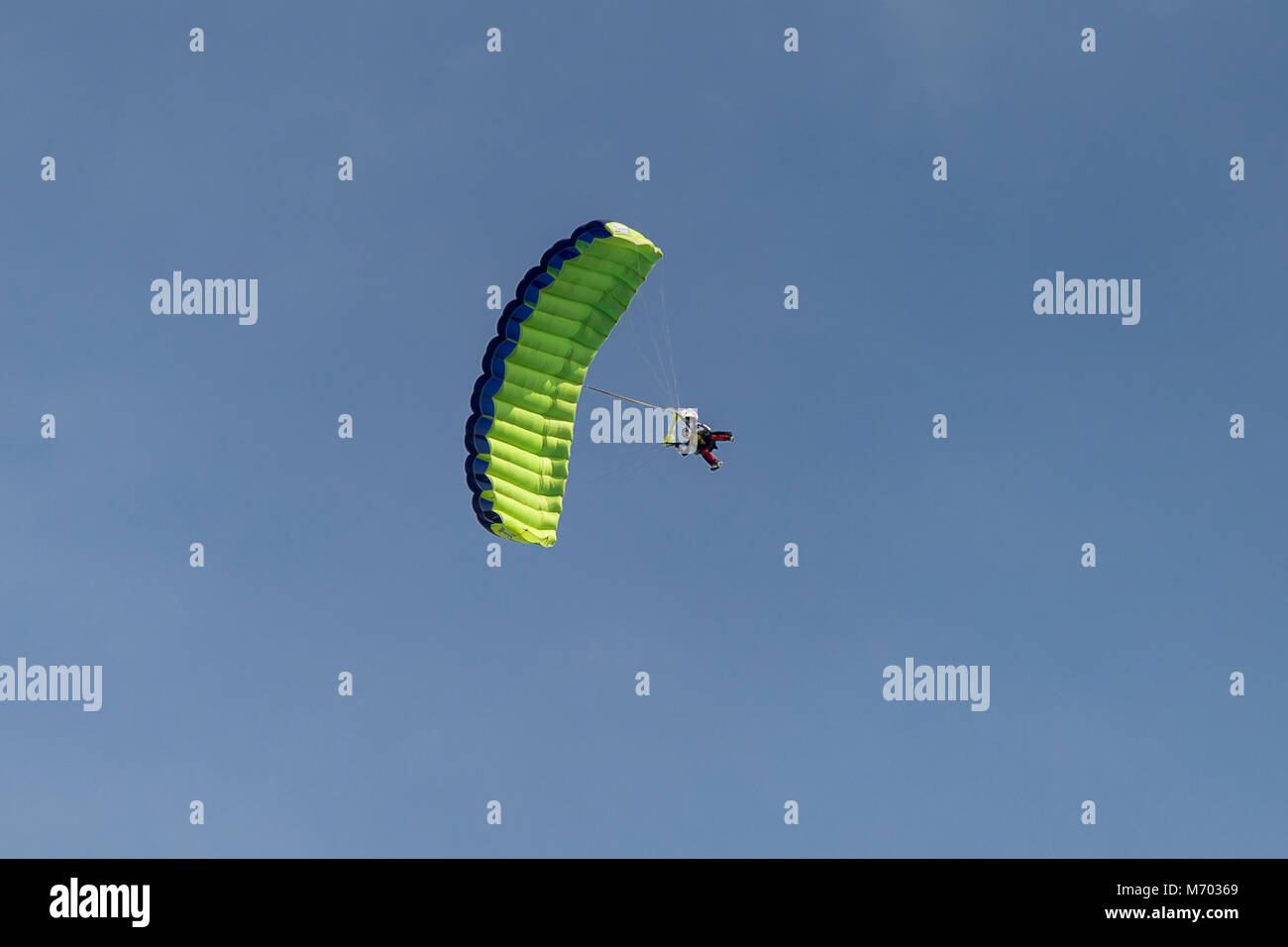Parachutists: Instructor and Beginner with Green Parachute preparing ...