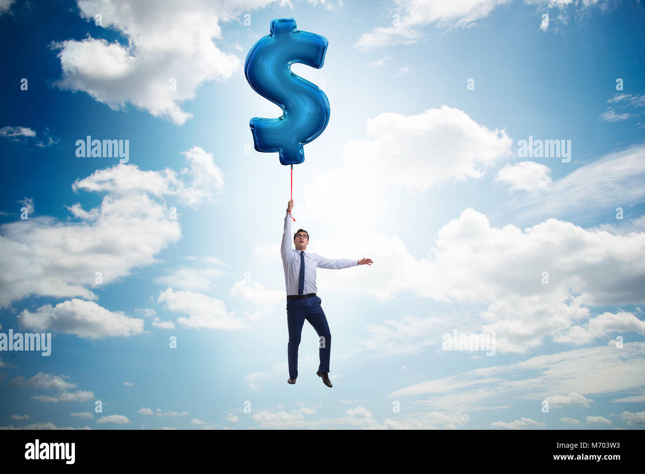 Businessman flying on dollar sign inflatable balloon Stock Photo - Alamy