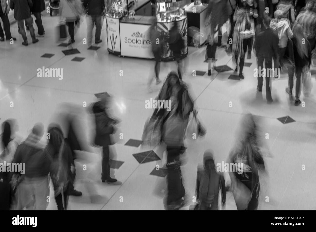 People walking through a shopping mall, taken with a slow exposure to ...