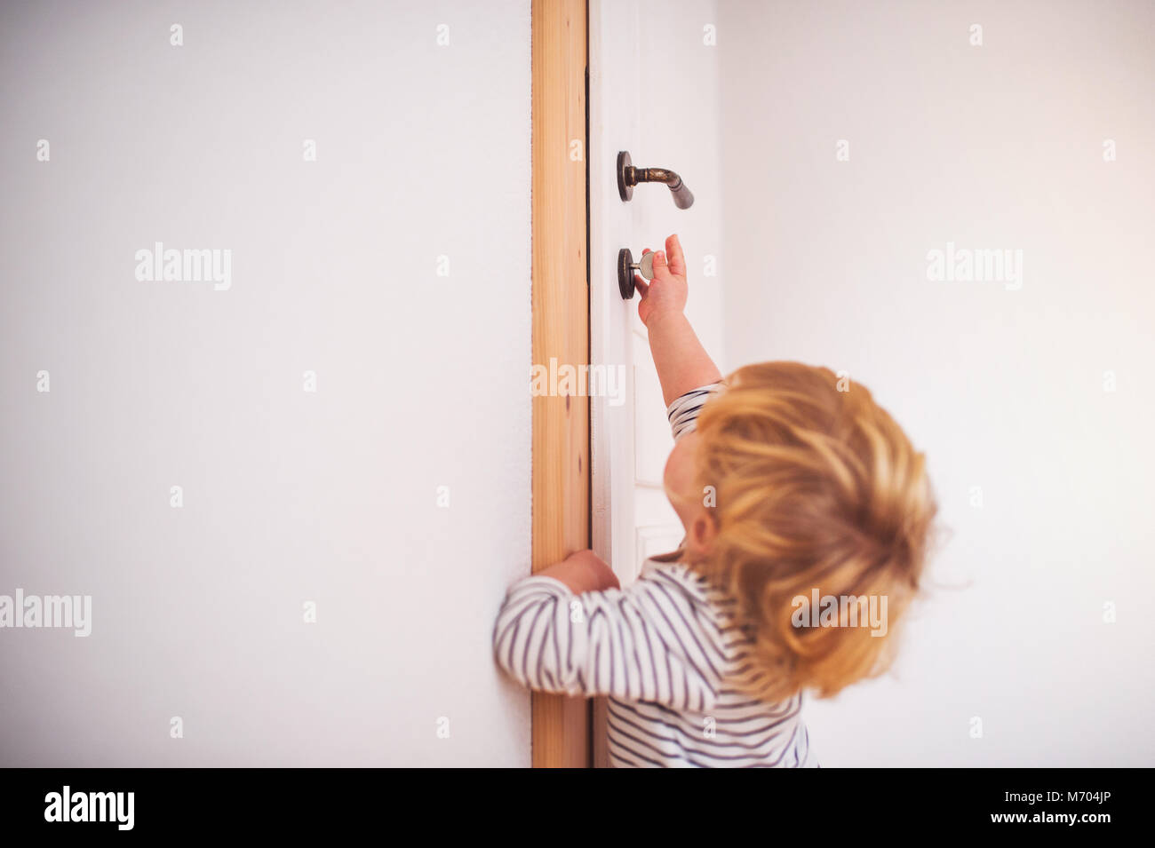 Toddler boy in a dangerous situation at home Stock Photo - Alamy