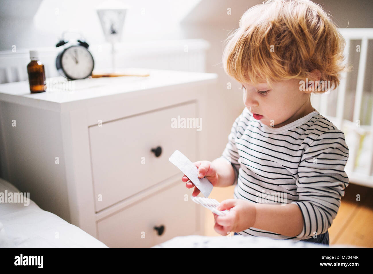 Toddler boy in a dangerous situation at home Stock Photo - Alamy