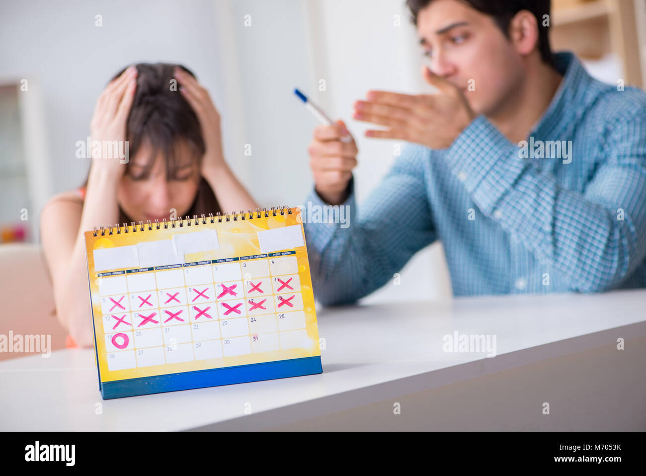 Young family in pregnancy planning concept with ovulation calendar ...