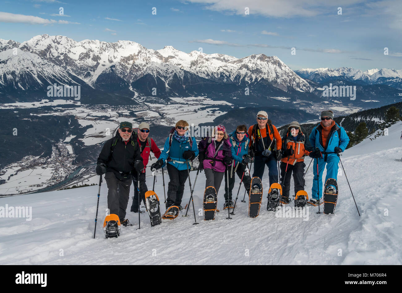 A group of Snow shoe hikers pose on the mountain above the Inn valley ...
