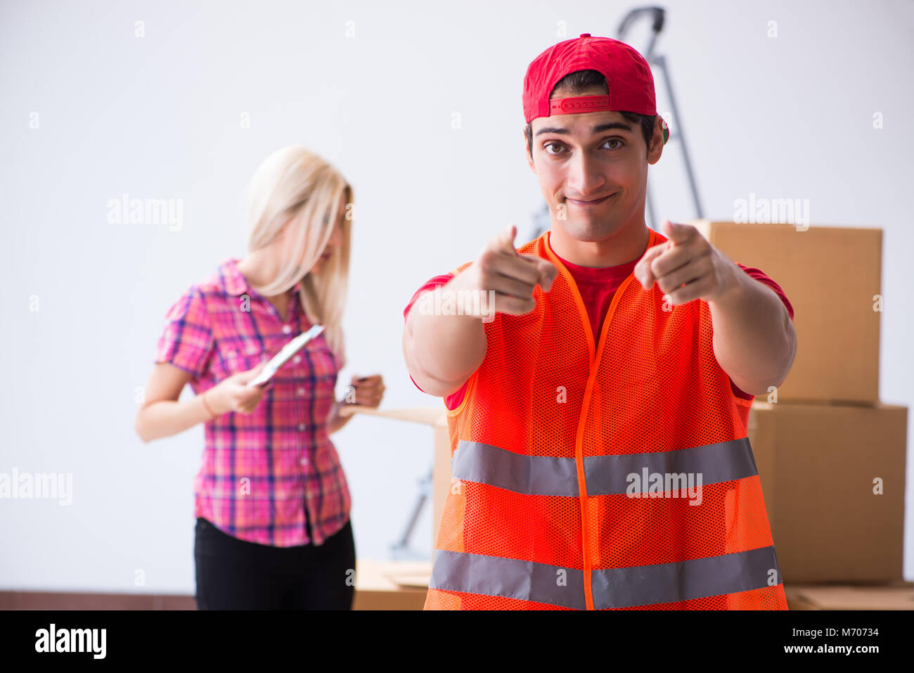 Young delivery assistant delivering to home Stock Photo - Alamy