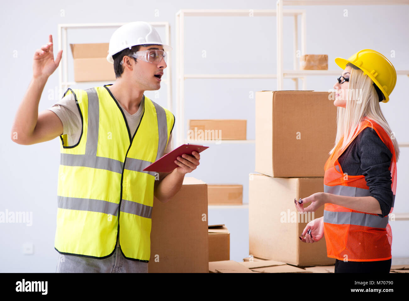 Delivery contractor delivering boxes to office Stock Photo - Alamy