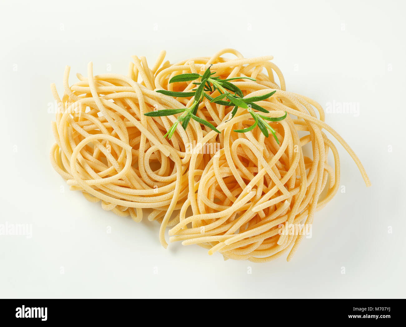 bundles of uncooked spaghetti pasta on white background Stock Photo - Alamy