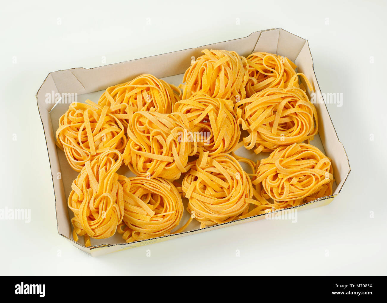 box of dried ribbon pasta bundles on white background Stock Photo - Alamy