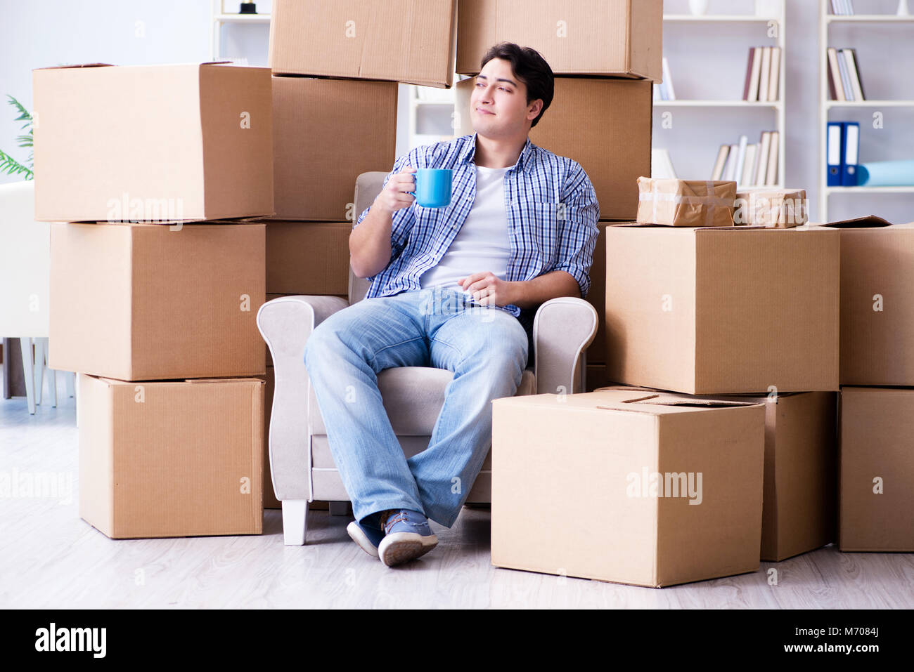 Young man moving in to new house with boxes Stock Photo - Alamy
