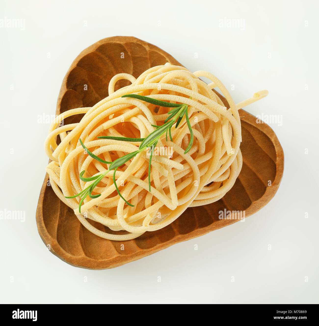 bundles of spaghetti pasta in wooden bowl Stock Photo - Alamy