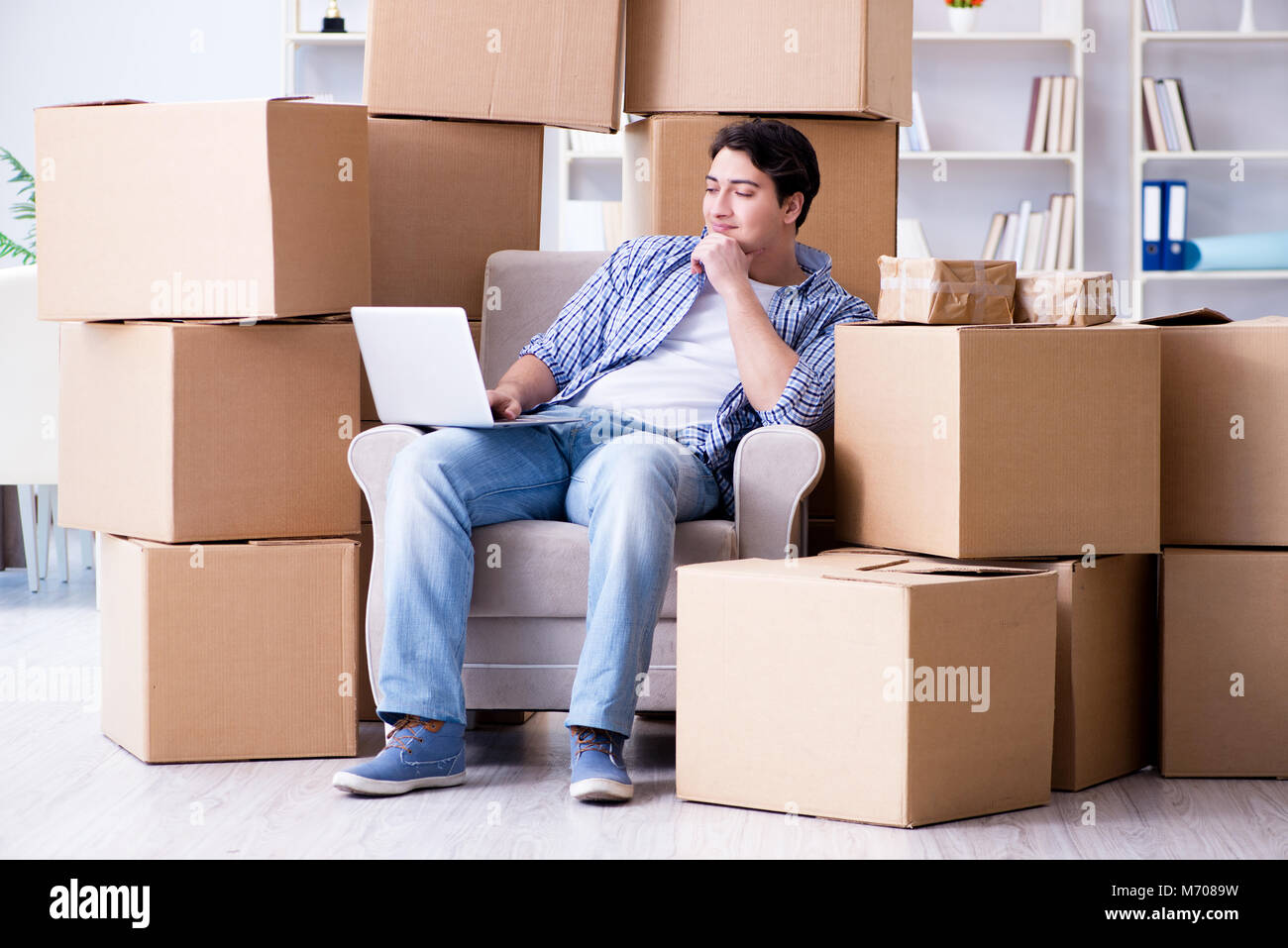 Young man moving in to new house with boxes Stock Photo - Alamy