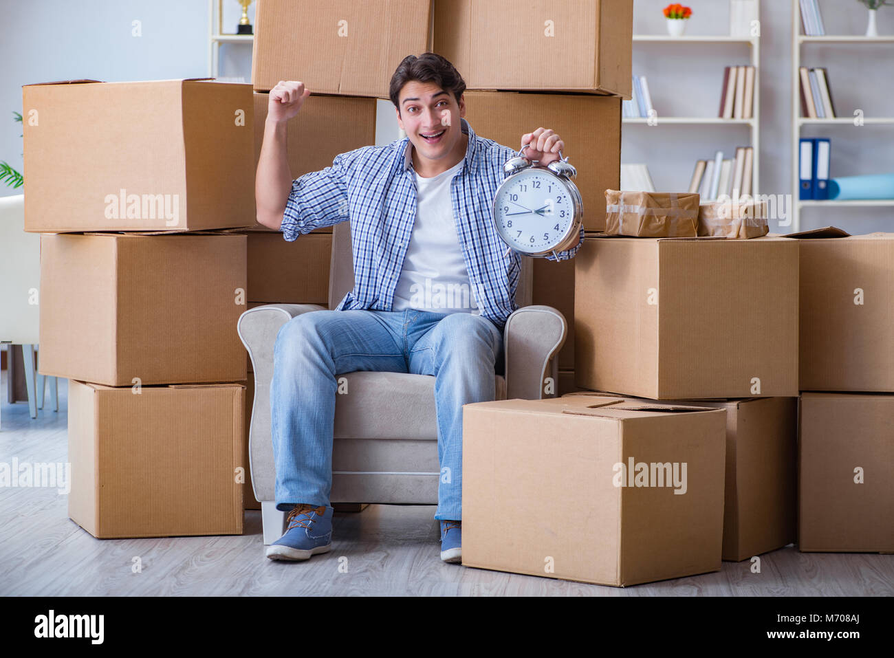 Young man moving in to new house with boxes Stock Photo - Alamy