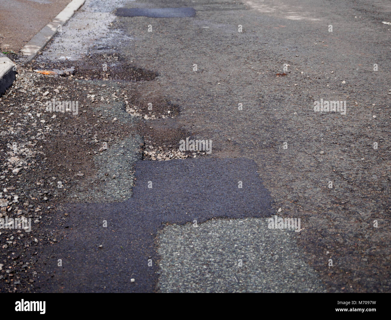 Potholes in a UK road Stock Photo - Alamy