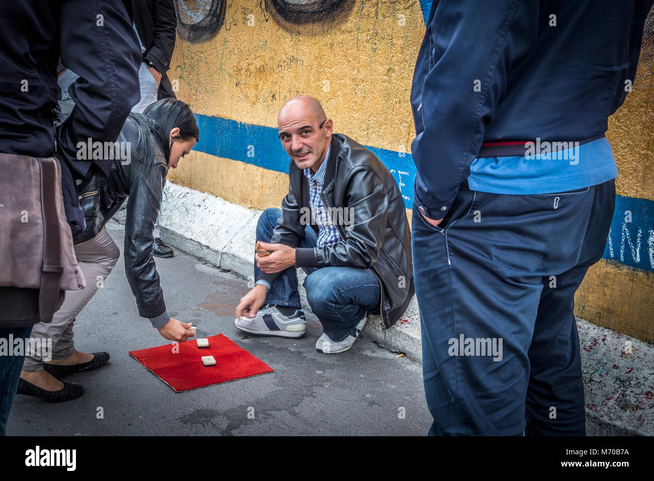 The shell game con taking place alongside the Berlin Wall Stock Photo ...