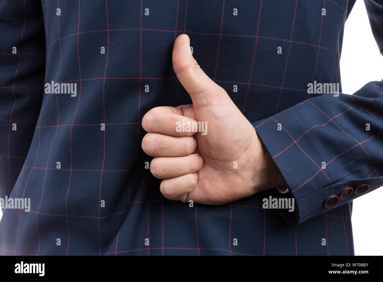 Business like or thumb-up gesture behind back as deal approval concept ...