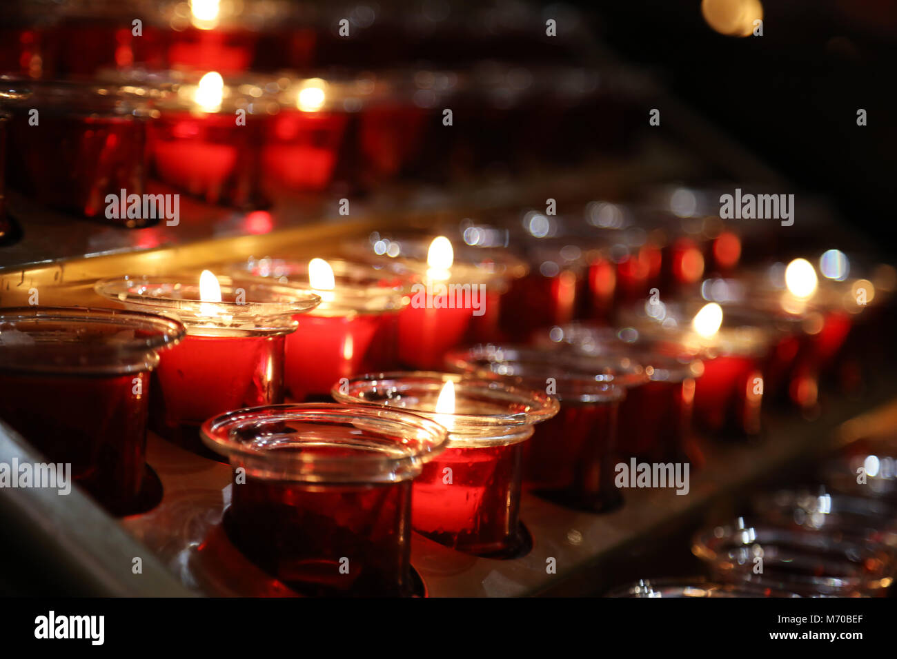 Background with red lights and candles in the church Stock Photo - Alamy