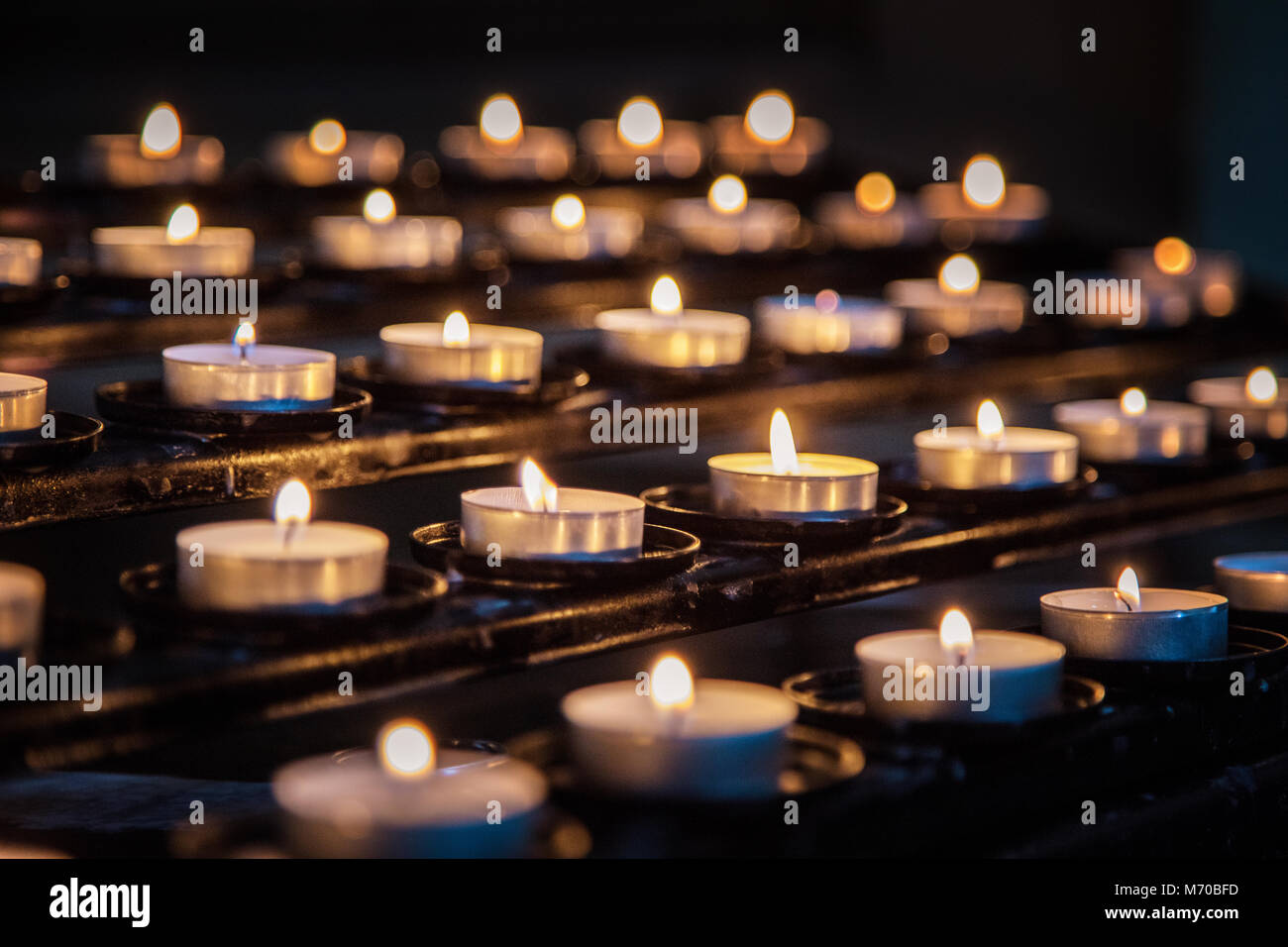 Background with red lights and candles in the church Stock Photo - Alamy