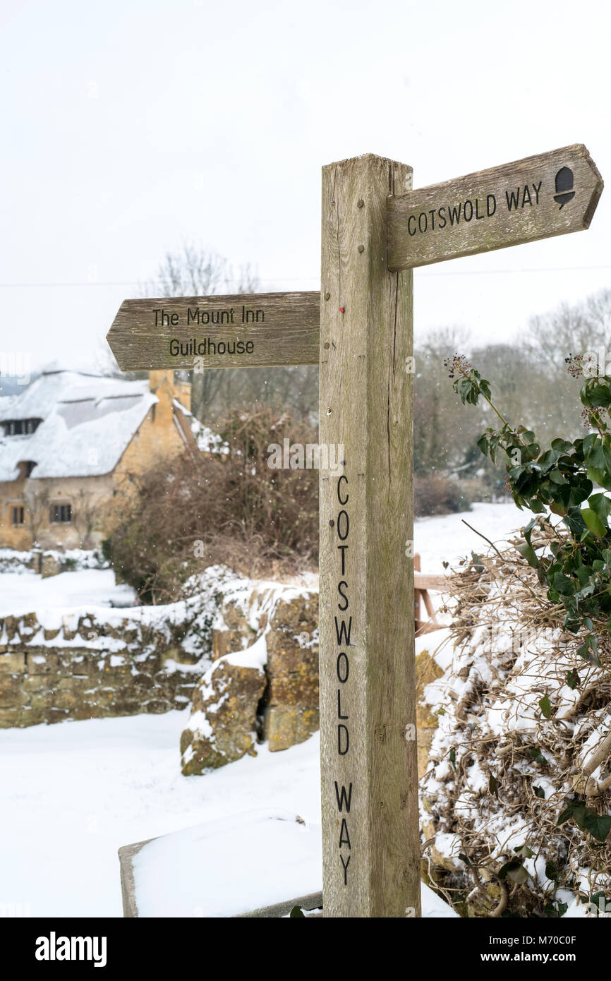 Cotswold way signpost in Stanton village in the winter snow. Stanton ...