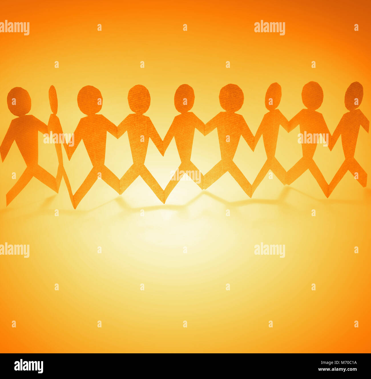 Team of paper chain people in a row holding hands Stock Photo - Alamy